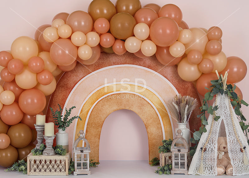Boho rainbow backdrop with balloon garland for birthday cake smash